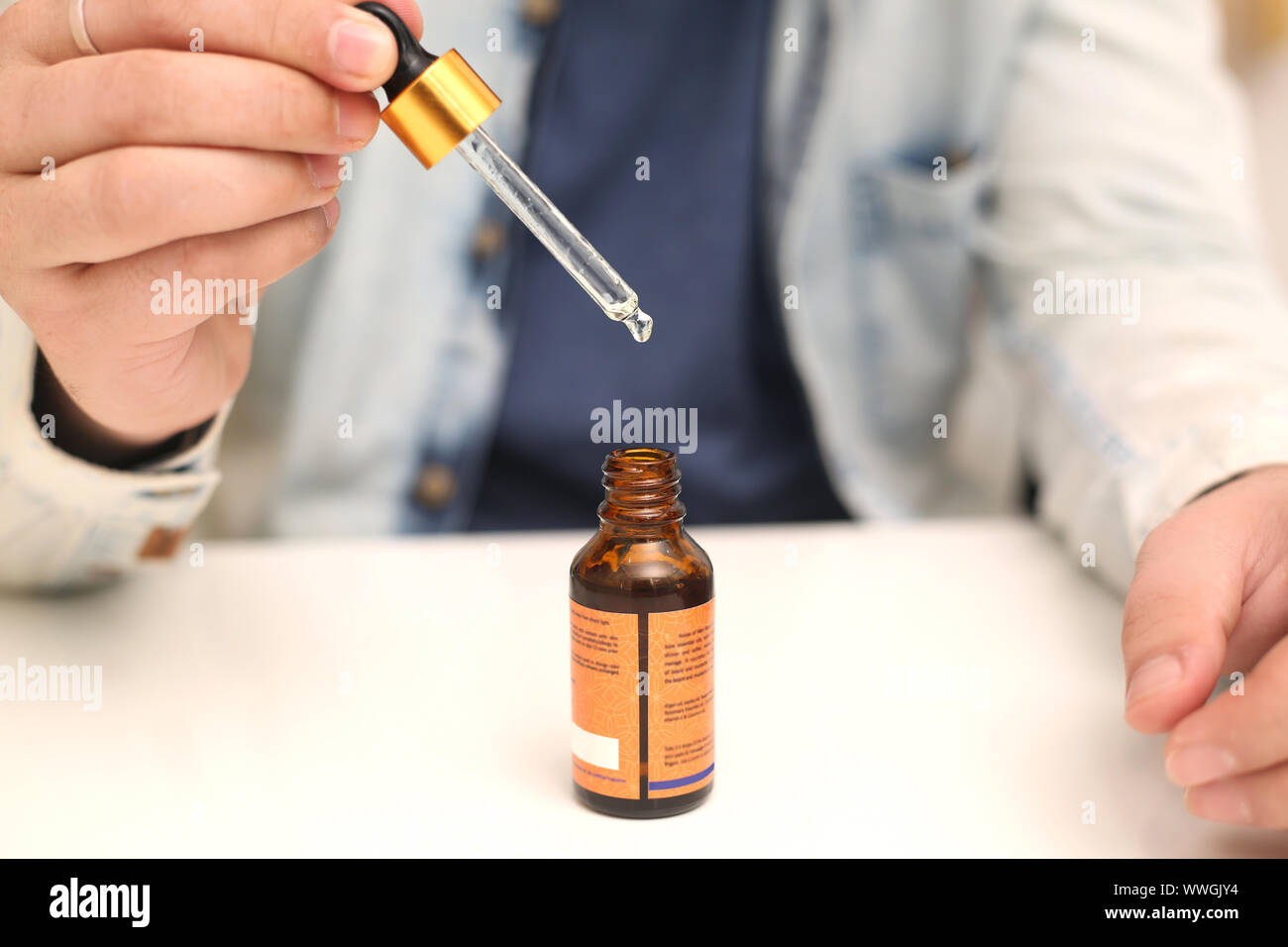 Picture of man drops medicine bottle holding in hand. Isolated on white ...