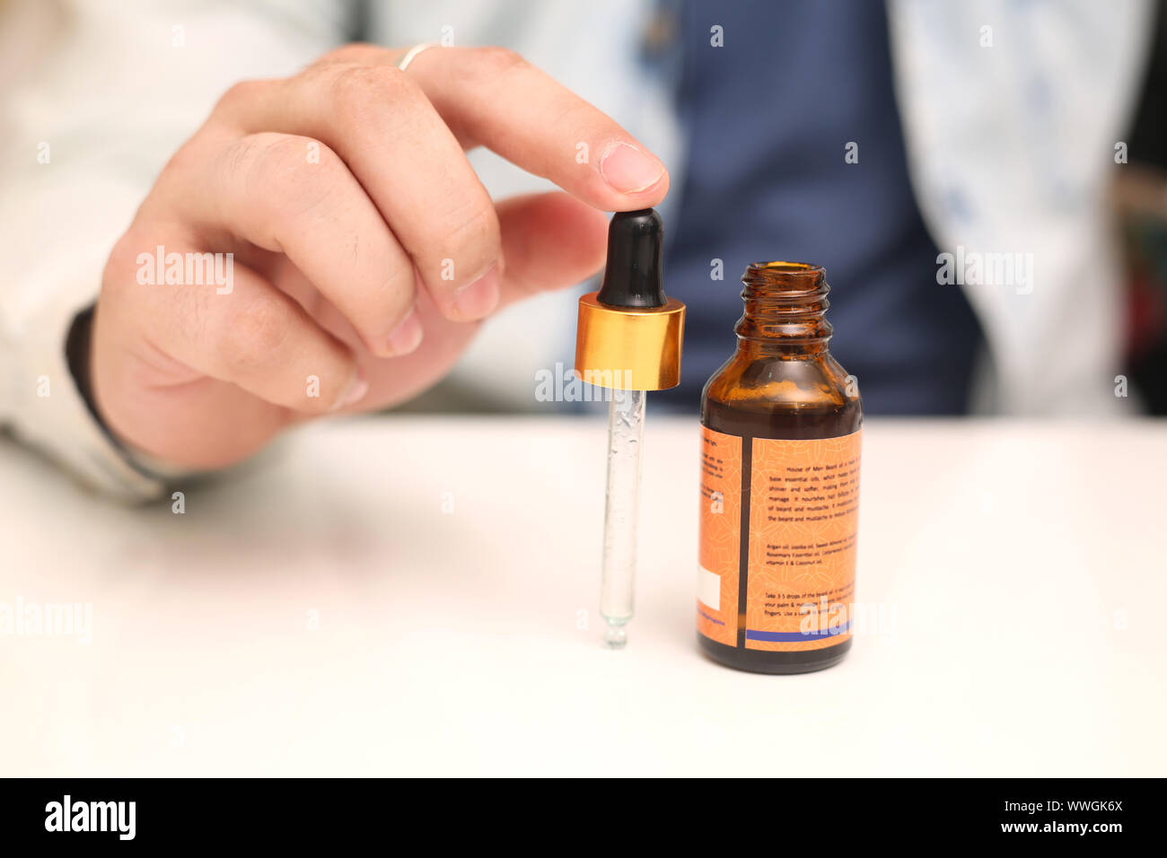 Picture of man drops medicine bottle holding in hand. Isolated on white ...