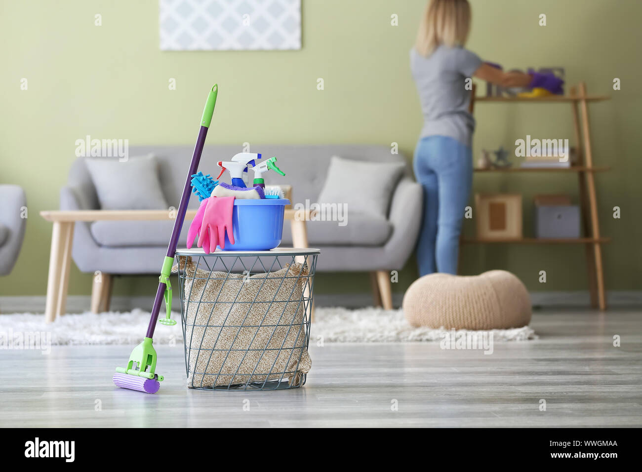 Set of cleaning supplies in room Stock Photo - Alamy