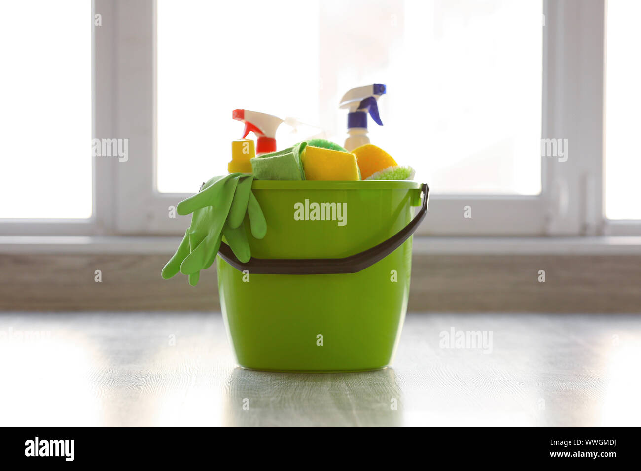 Set of cleaning supplies in room Stock Photo - Alamy
