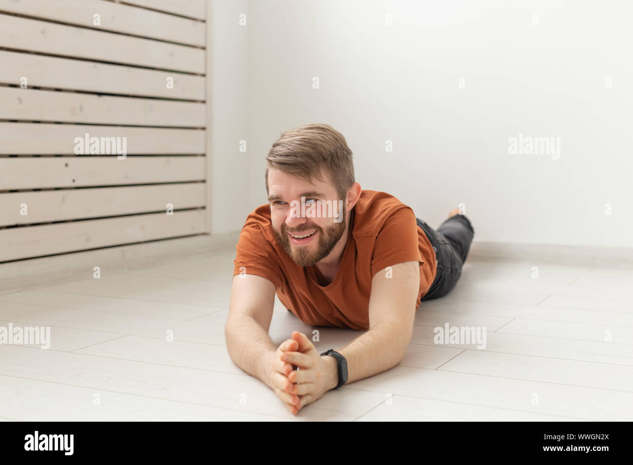 Relaxed and casual young man relaxing on the floor Stock Photo - Alamy