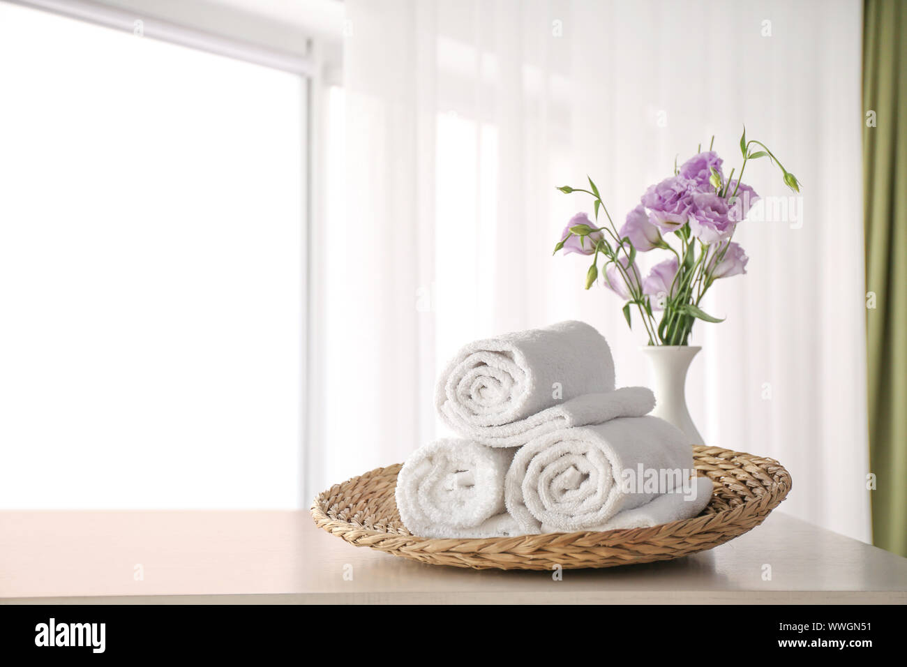 Clean towels on table in room Stock Photo - Alamy