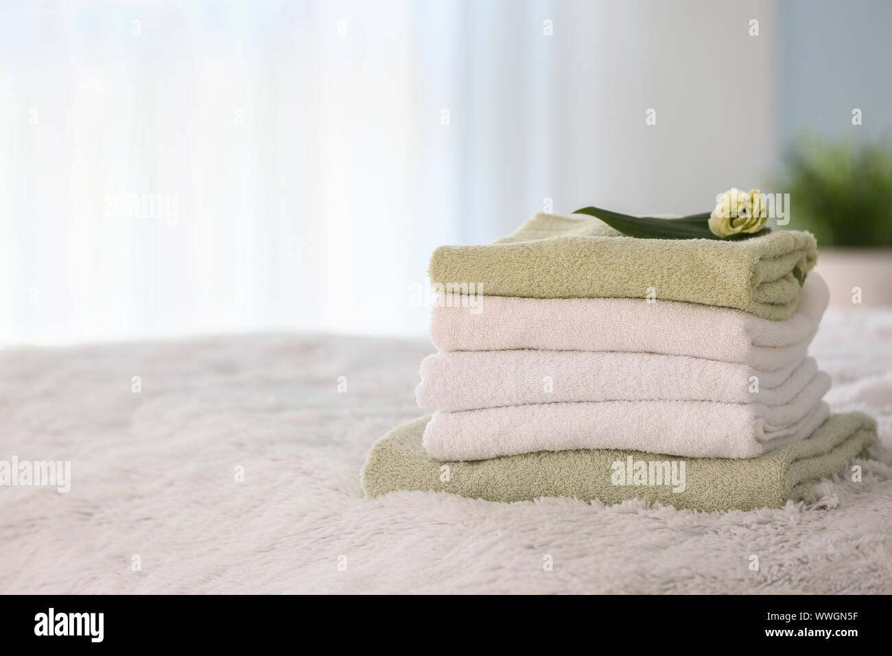 Stack of clean towels on bed Stock Photo - Alamy