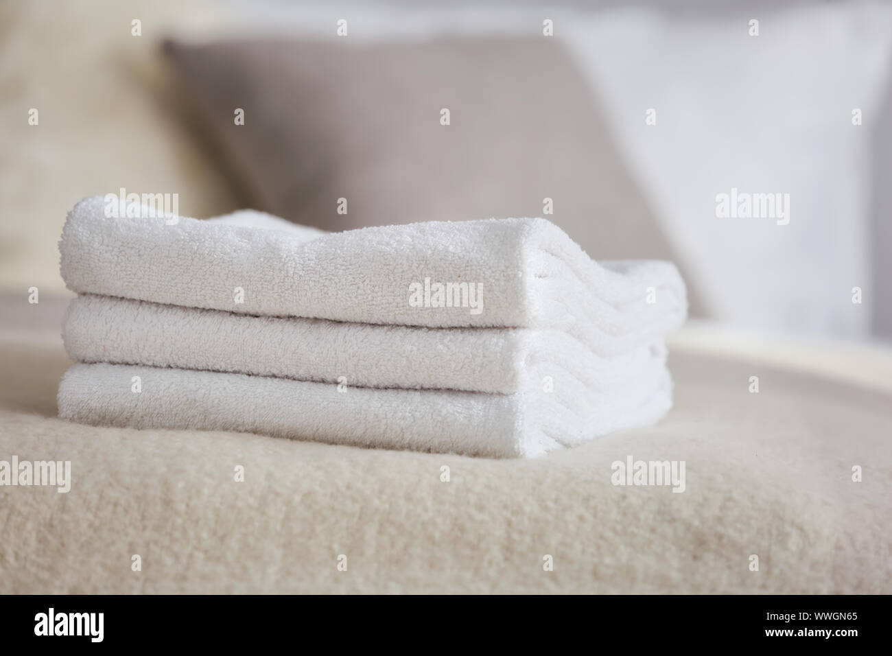 Stack of clean towels on bed Stock Photo - Alamy