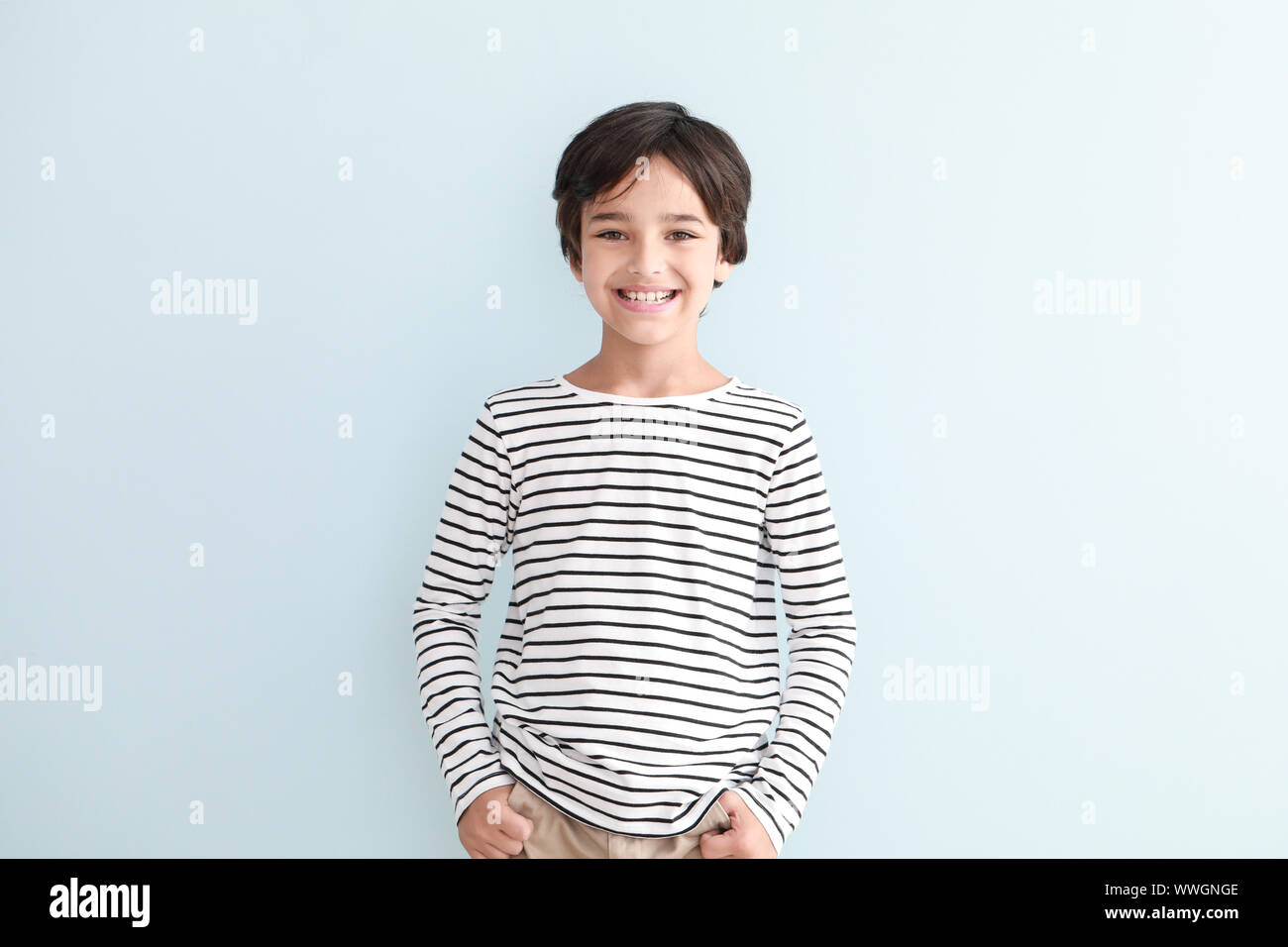 Happy little boy on light background Stock Photo - Alamy