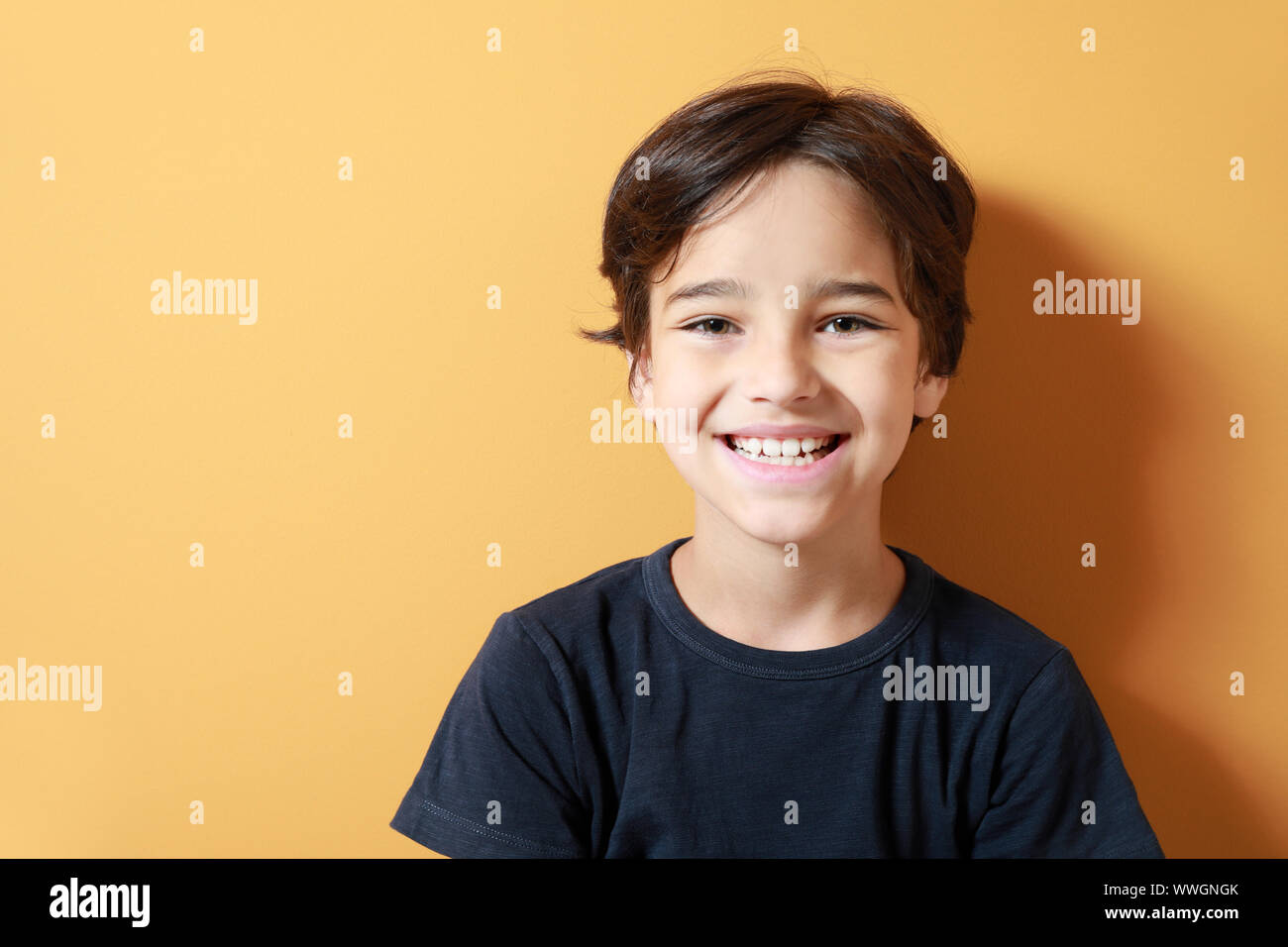Cute little boy on color background Stock Photo - Alamy