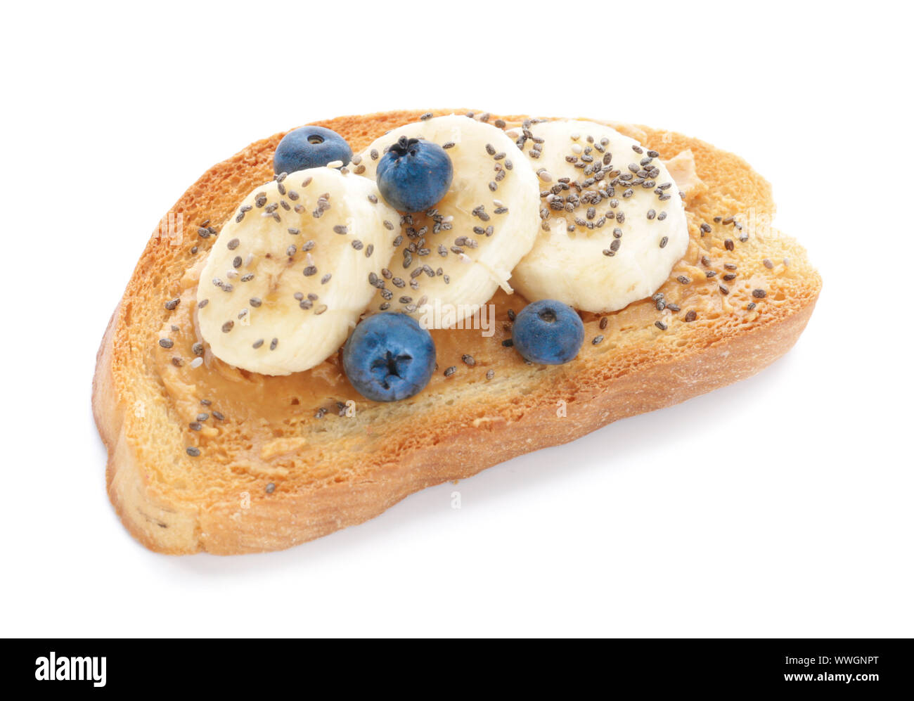Tasty toasted bread with fruits and peanut butter on white background ...