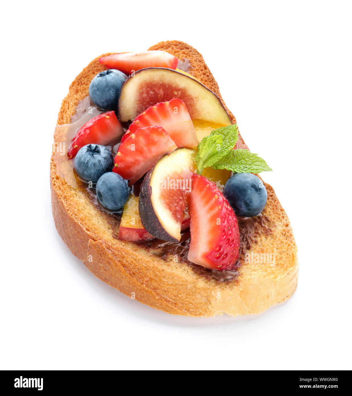 Tasty toasted bread with fruits on white background Stock Photo - Alamy