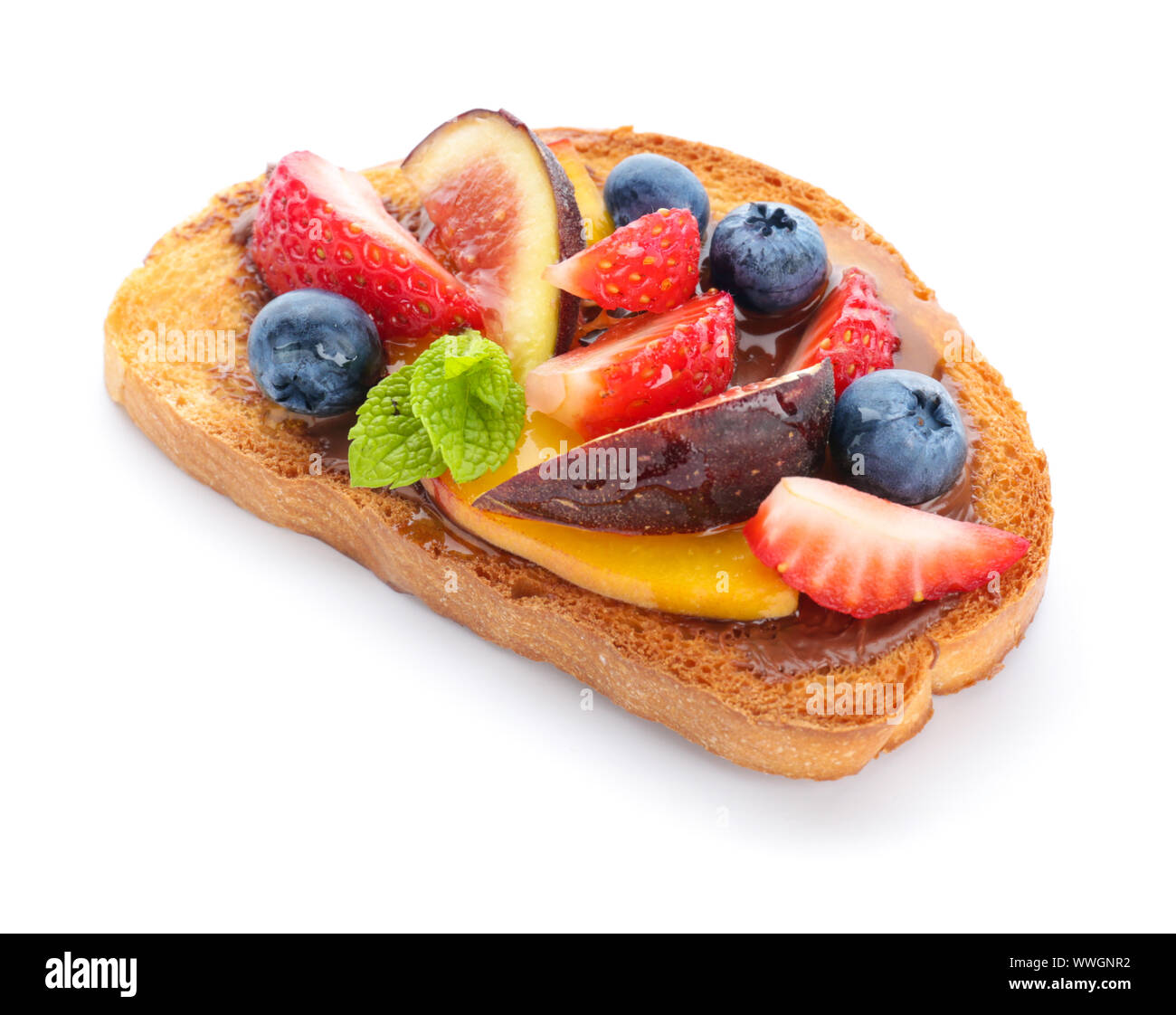 Tasty toasted bread with fruits on white background Stock Photo - Alamy