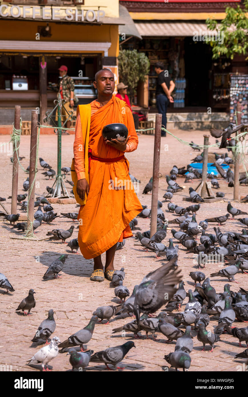 A monk collecting charity at Boudhanath, Kathmandu, Nepal Stock Photo ...