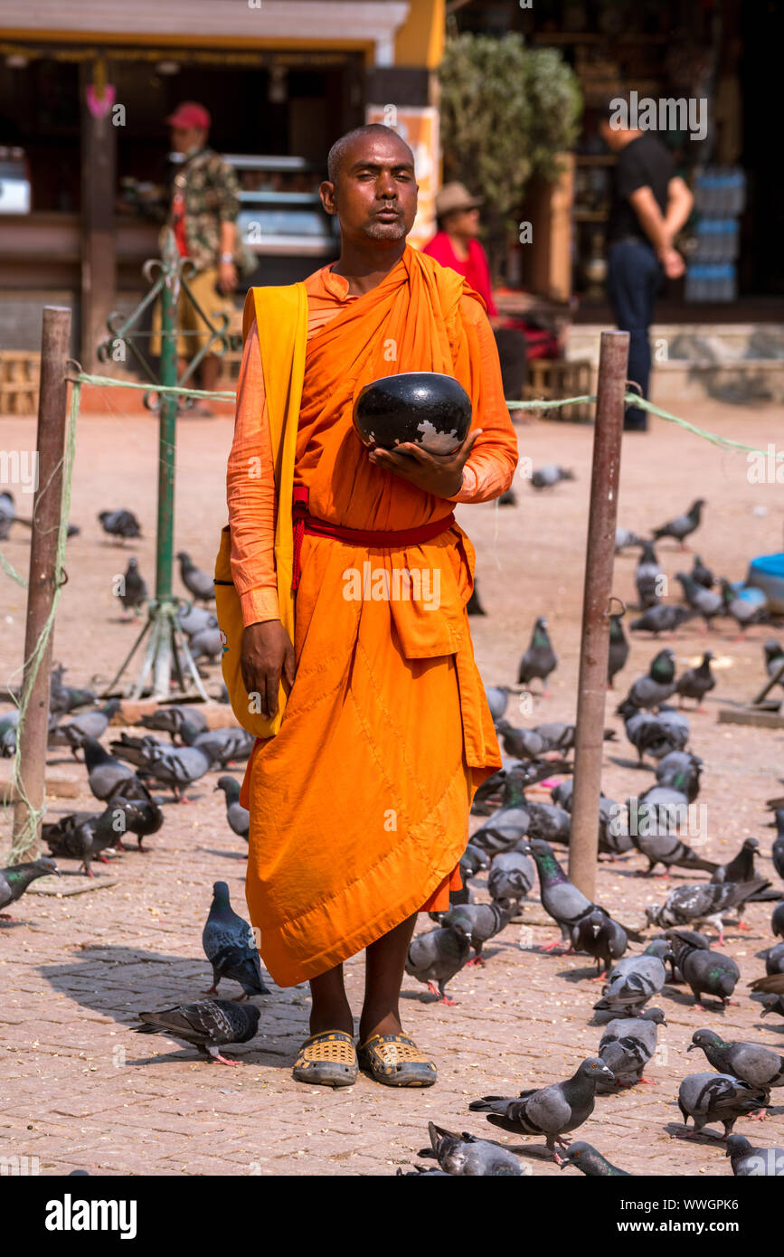 A monk collecting charity at Boudhanath, Kathmandu, Nepal Stock Photo ...