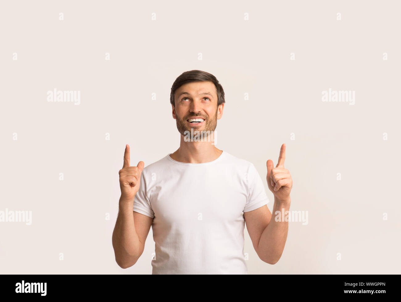 Man Pointing Fingers Upward, White Background, Studio Shot Stock Photo ...