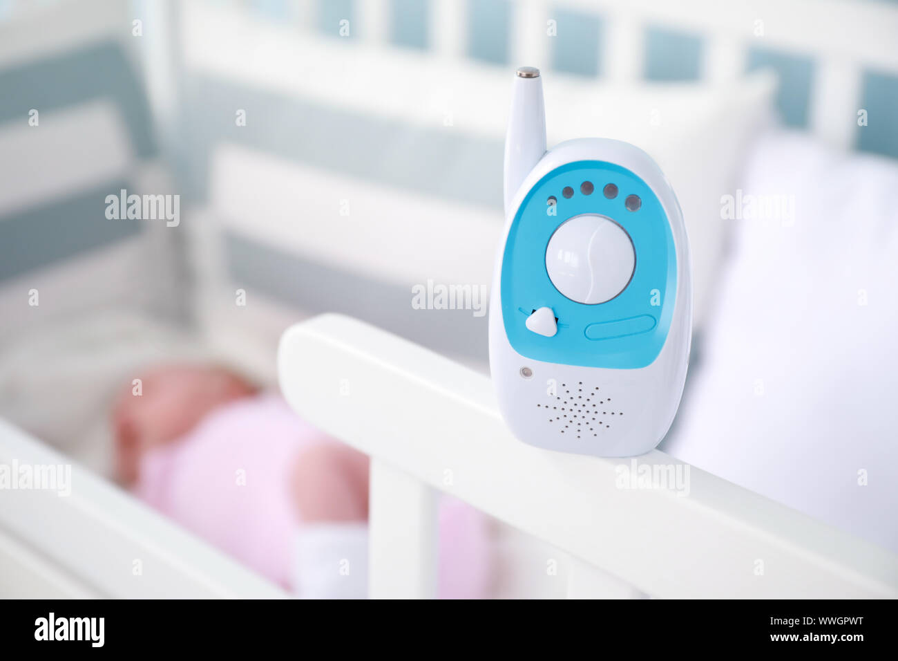 Radio nanny on bed with sleeping baby Stock Photo - Alamy