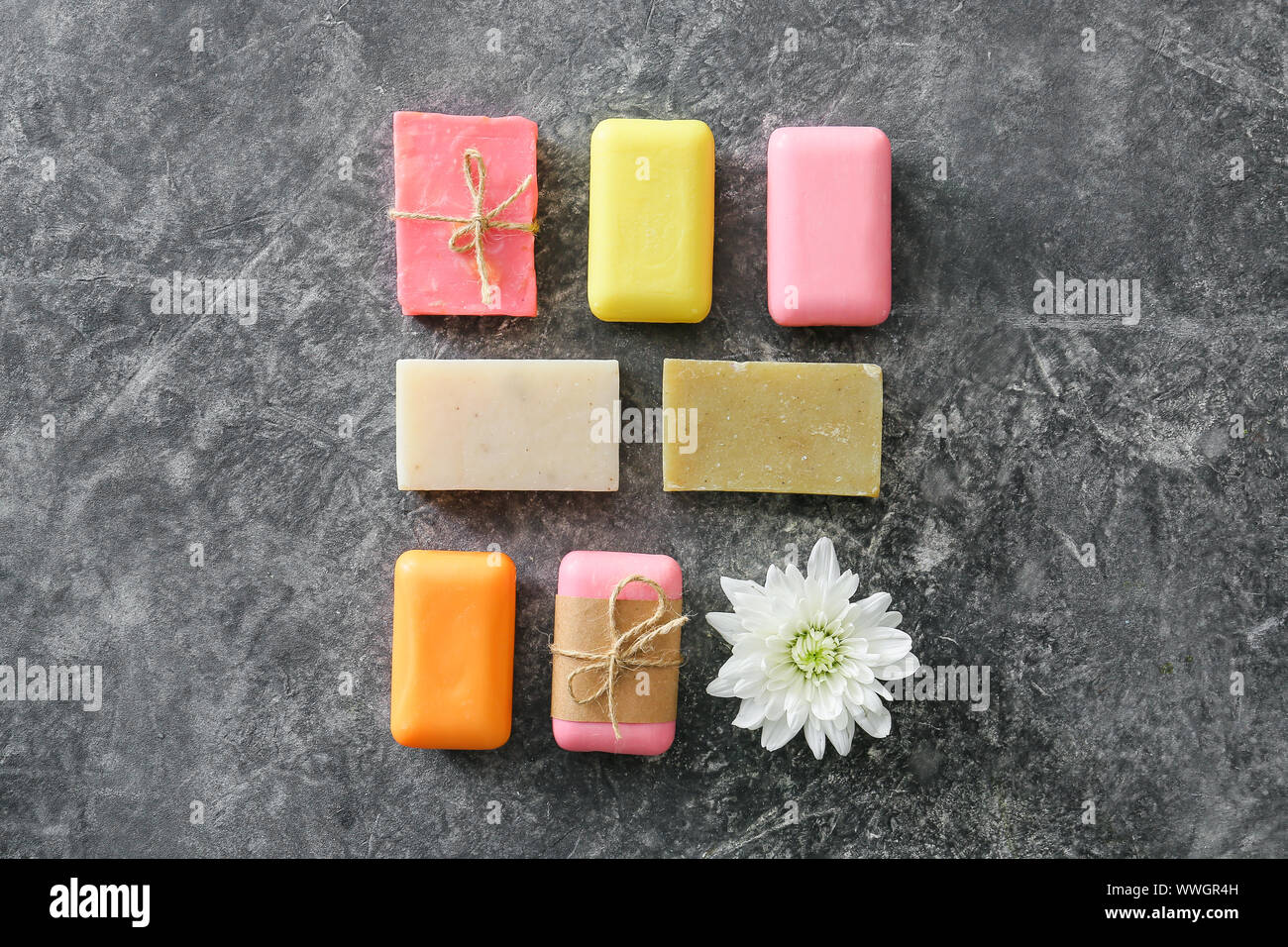 Different soap on grey background Stock Photo - Alamy