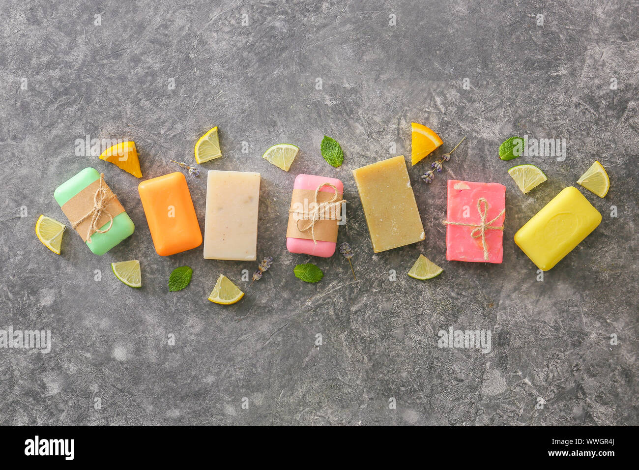Different soap on grey background Stock Photo - Alamy