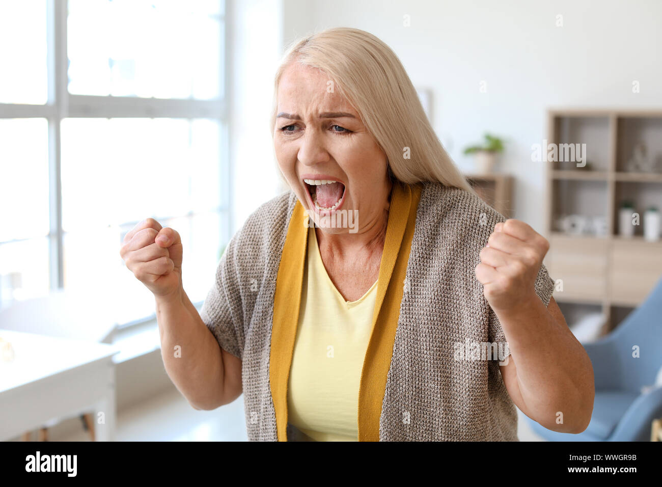 Angry mature woman at home Stock Photo - Alamy