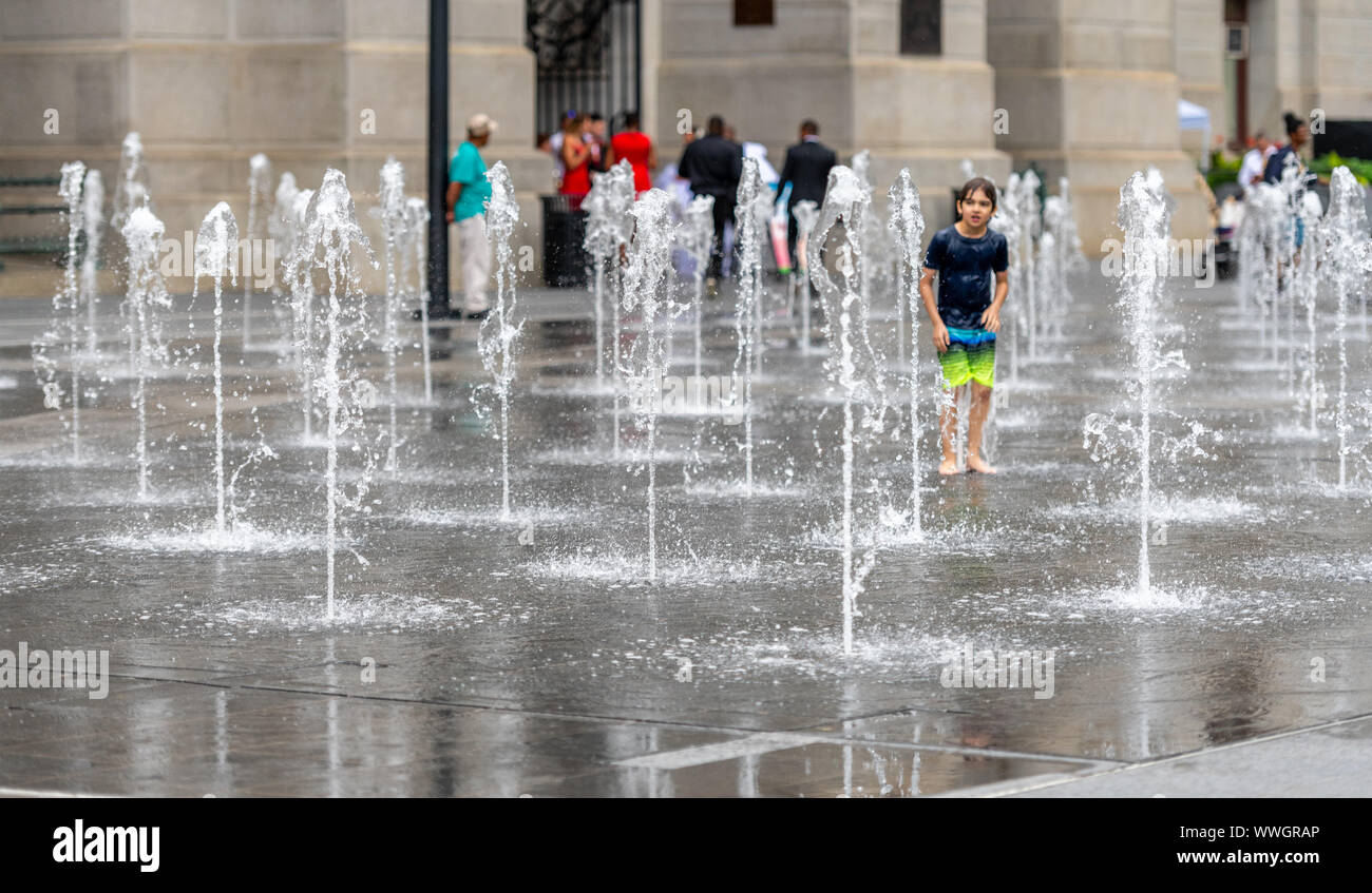 A little boy playing in the fountains at Dilworth Park by Philadelphia ...