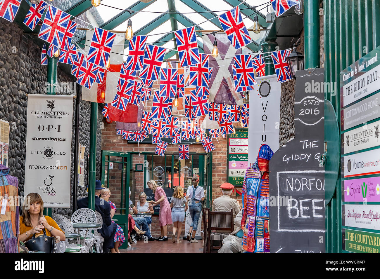 People in the Courtyard cafe in Sheringham high Street Norfolk Stock ...