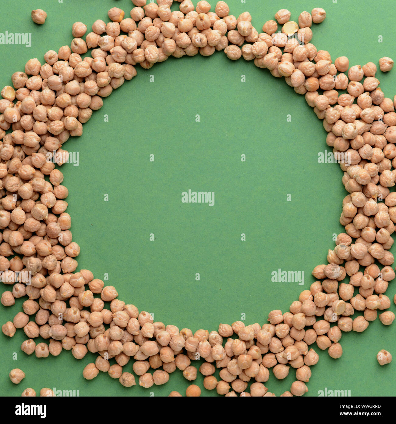 Frame made of raw chickpea on color background Stock Photo - Alamy