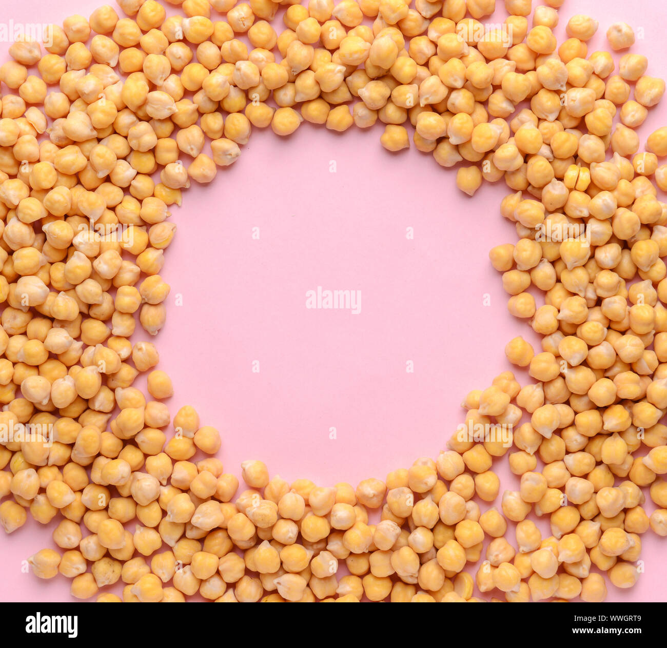 Frame made of raw chickpea on color background Stock Photo - Alamy