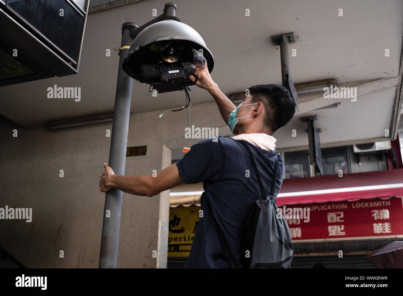 Hong Kong. 15th Sep, 2019. A protester destroys a surveillance camera ...