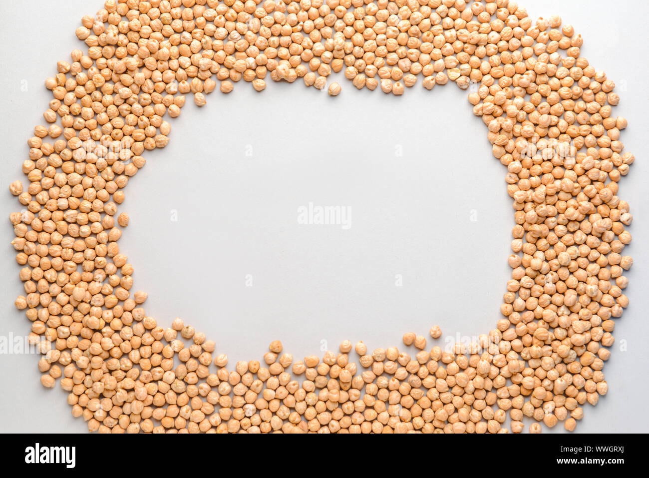 Frame made of raw chickpea on light background Stock Photo - Alamy