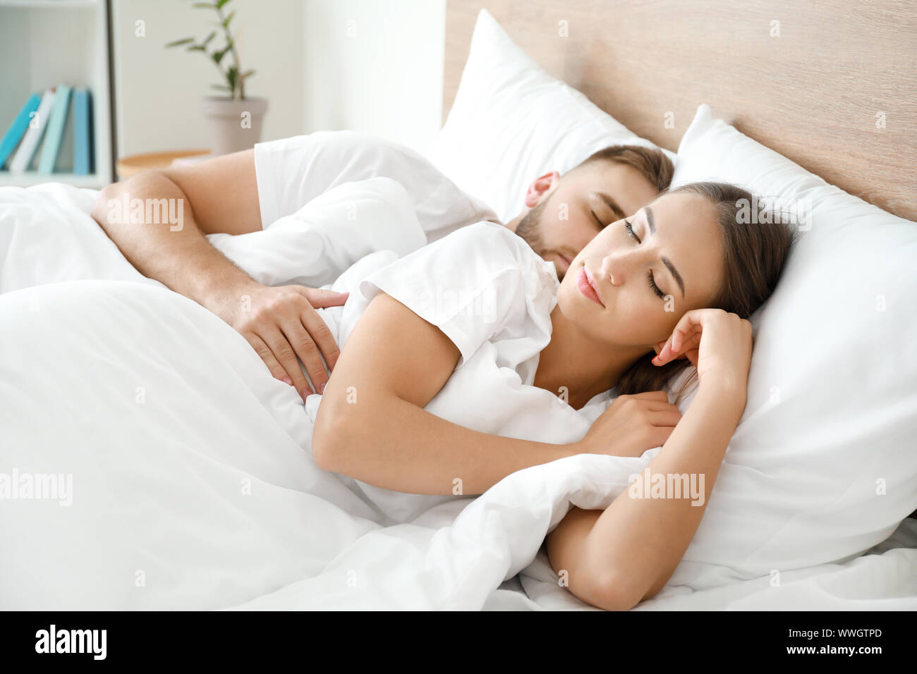 Morning of young couple sleeping in bed Stock Photo - Alamy
