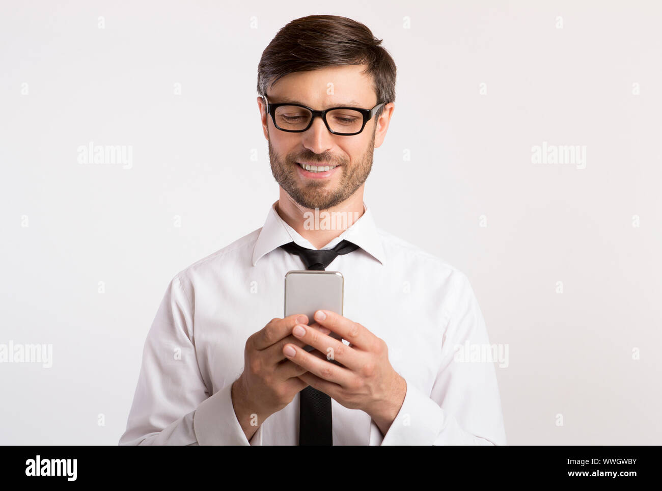 Smiling Man Texting On Cellphone Over White Background Stock Photo - Alamy