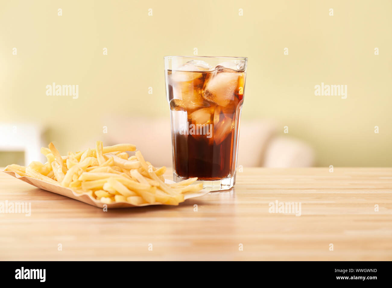 Glass of cold cola and french fries on table Stock Photo - Alamy