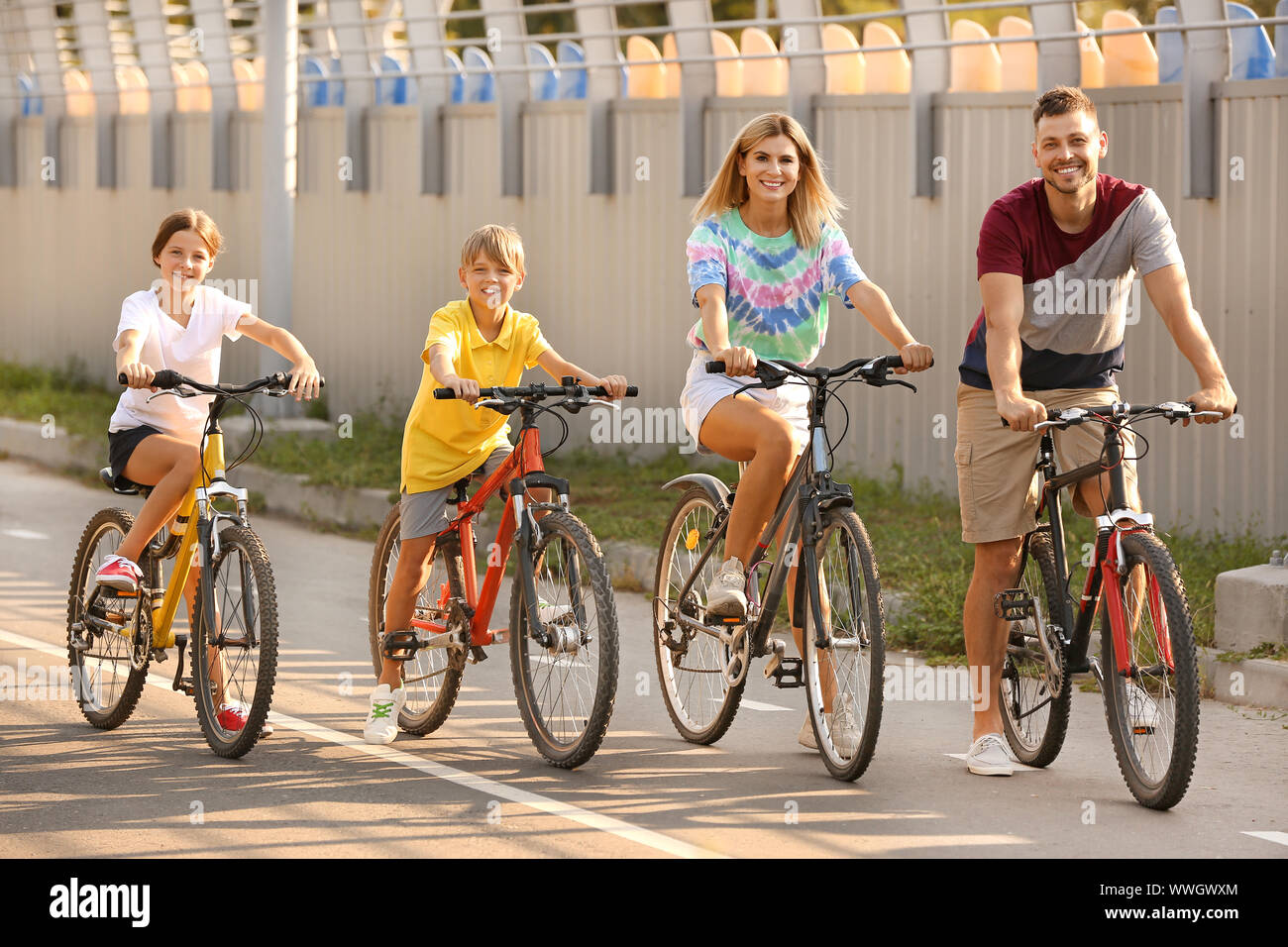 Happy family riding bicycles outdoors Stock Photo - Alamy