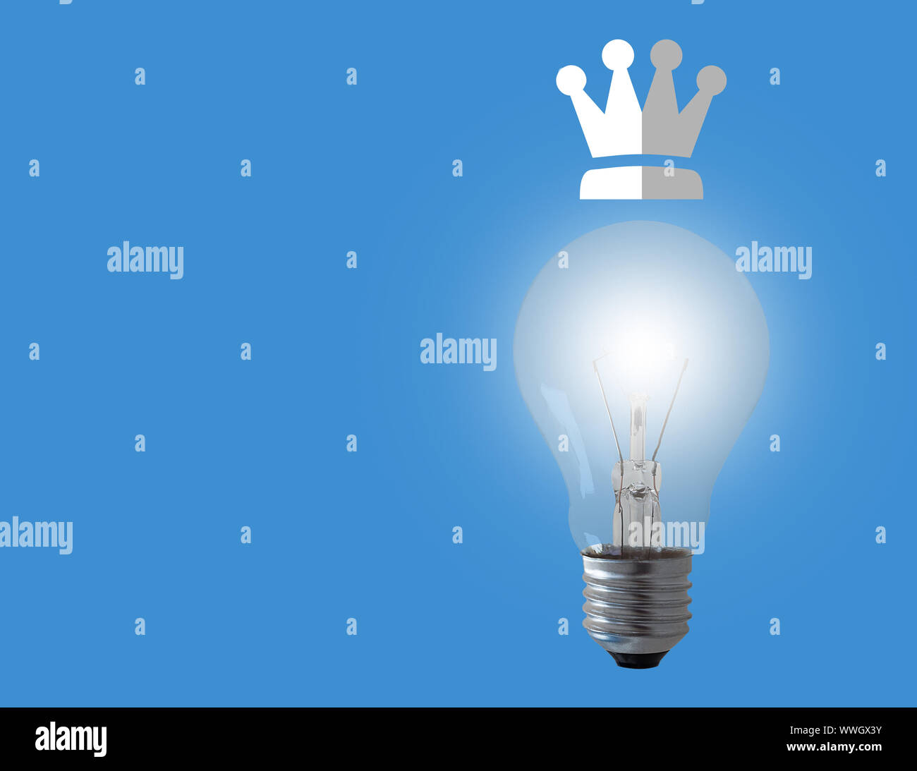 Think big concept, light bulb and crown on blue background, business ...