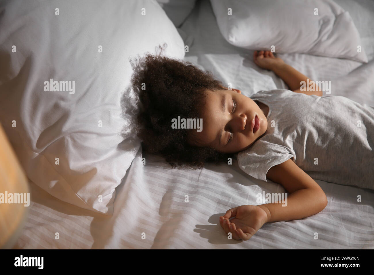 Little African-American girl sleeping in bed at night Stock Photo - Alamy