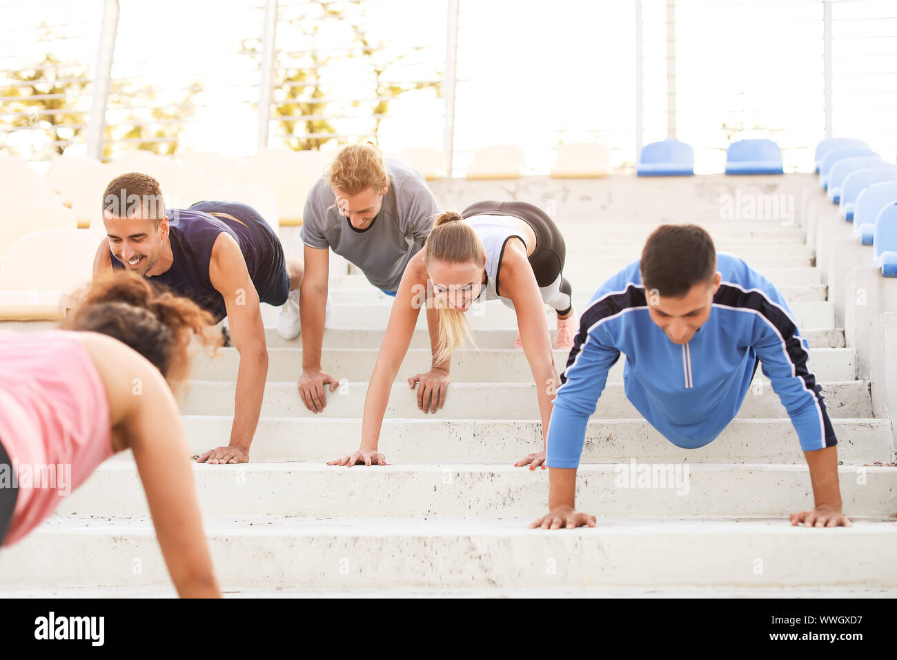 Group of sporty young people training at the stadium Stock Photo - Alamy