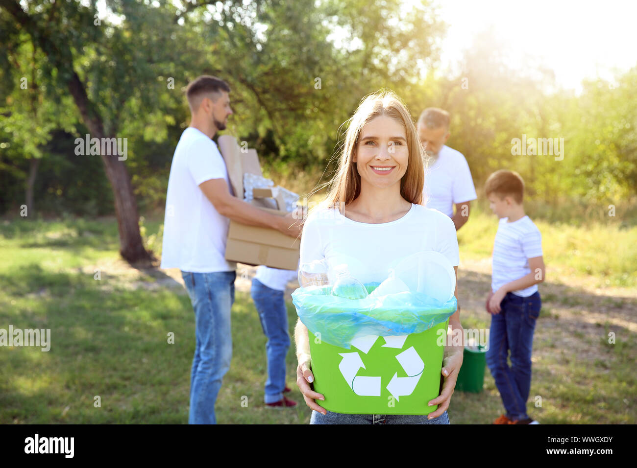 People gathering garbage outdoors. Concept of recycling Stock Photo - Alamy
