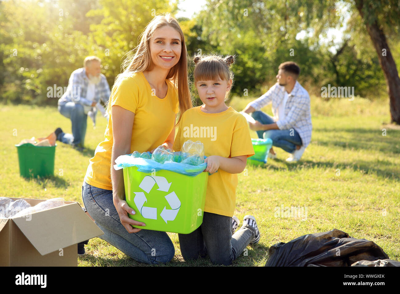 People gathering garbage outdoors. Concept of recycling Stock Photo - Alamy