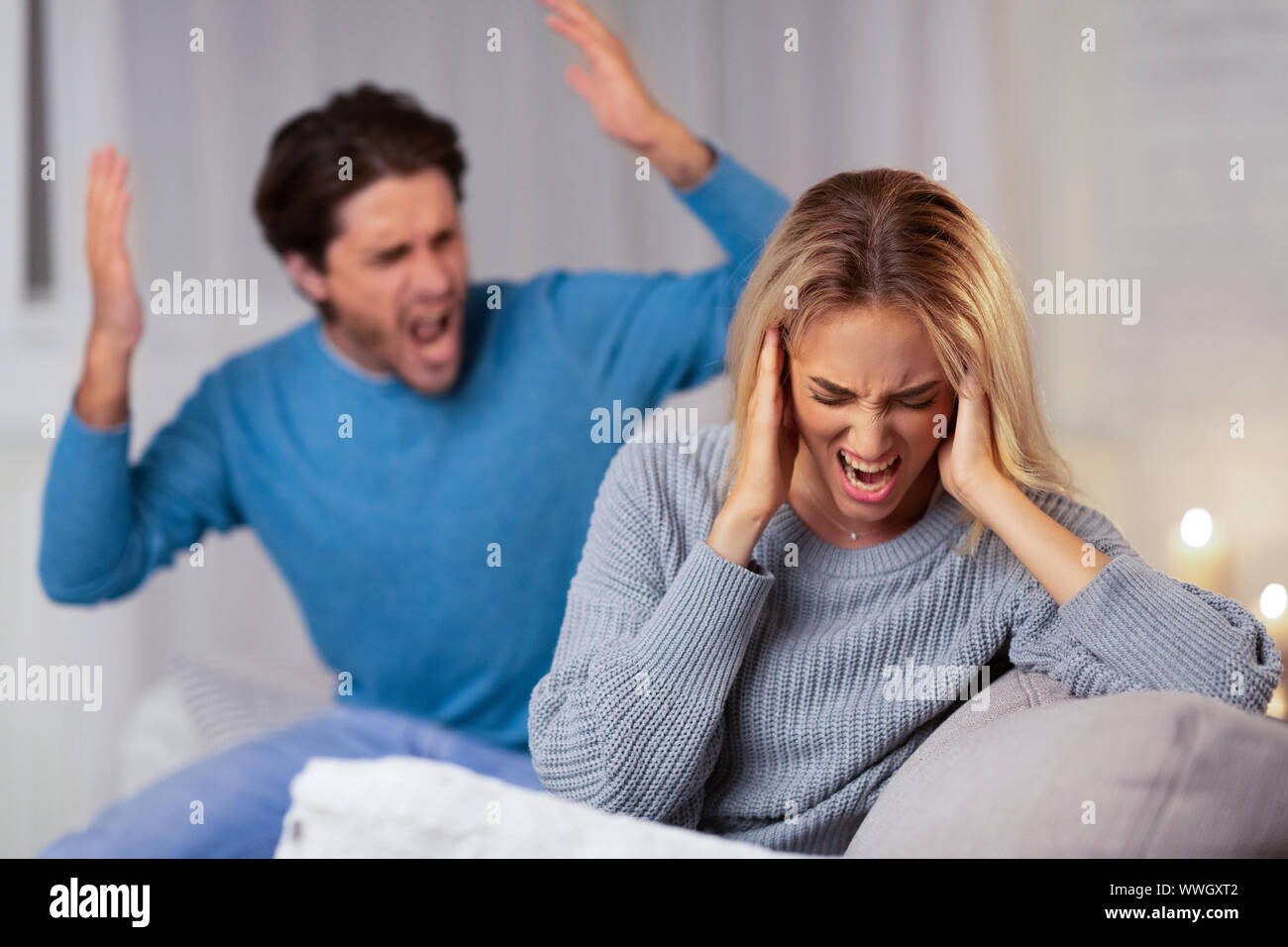 Angry Boyfriend Shouting At Girlfriend Sitting On Couch Indoor Stock ...