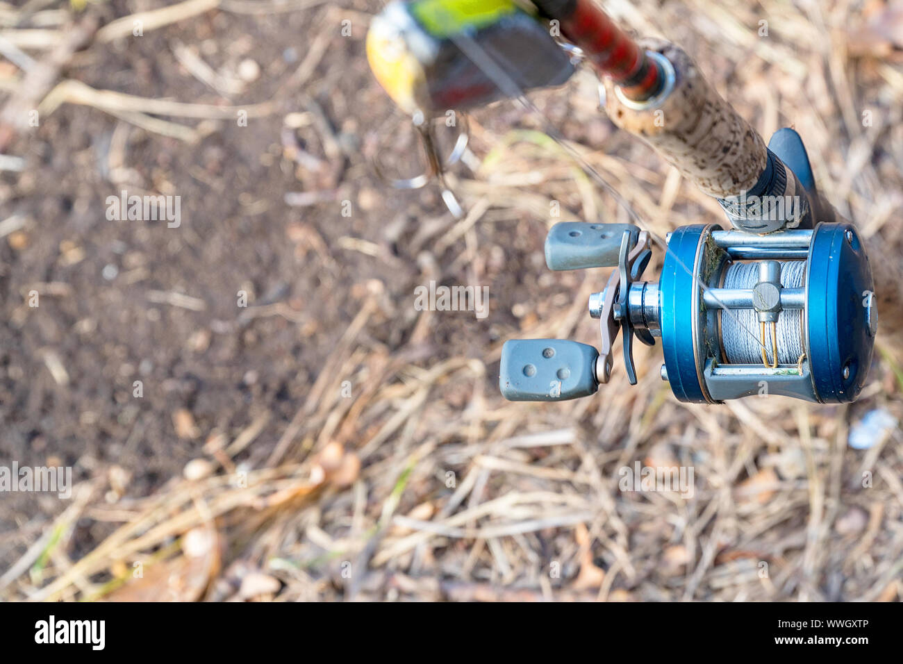 Spinning rod with baitcasting reel and bait Stock Photo - Alamy