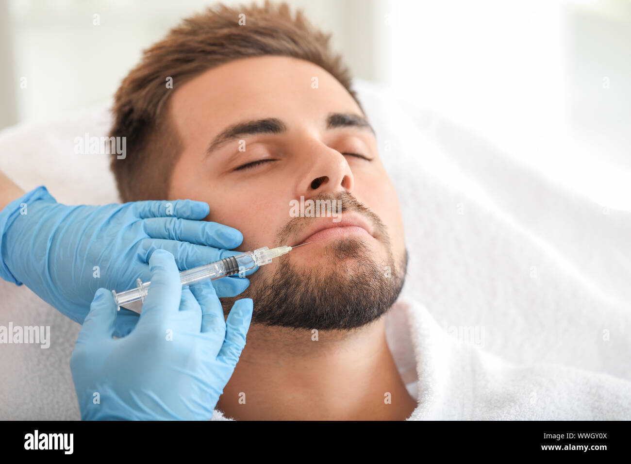 Handsome woman receiving injection in hi-res stock photography and ...