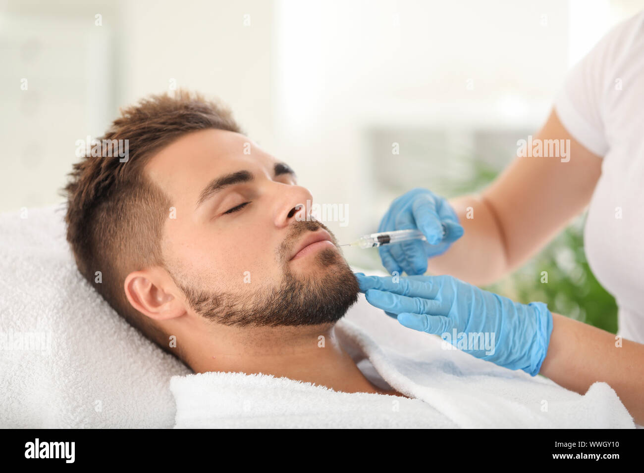 Handsome woman receiving injection in hi-res stock photography and ...