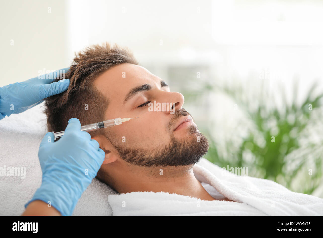 Handsome woman receiving injection in hi-res stock photography and ...