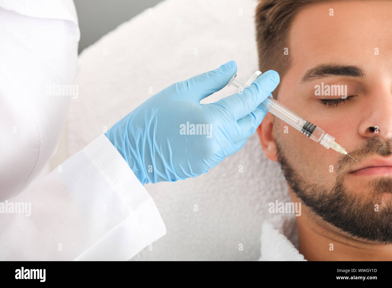 Handsome woman receiving injection in hi-res stock photography and ...