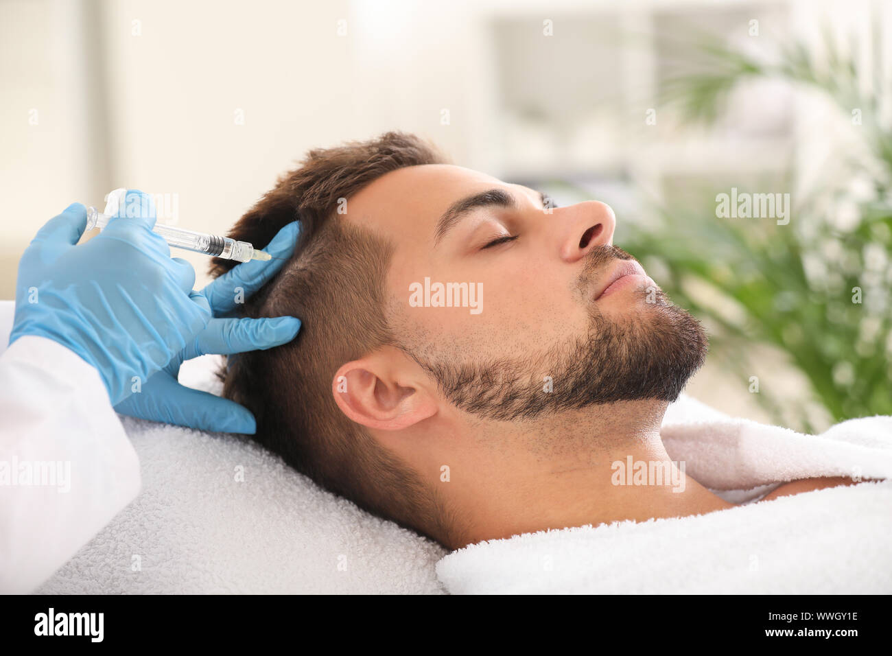 Man with hair loss problem receiving injection in clinic Stock Photo ...
