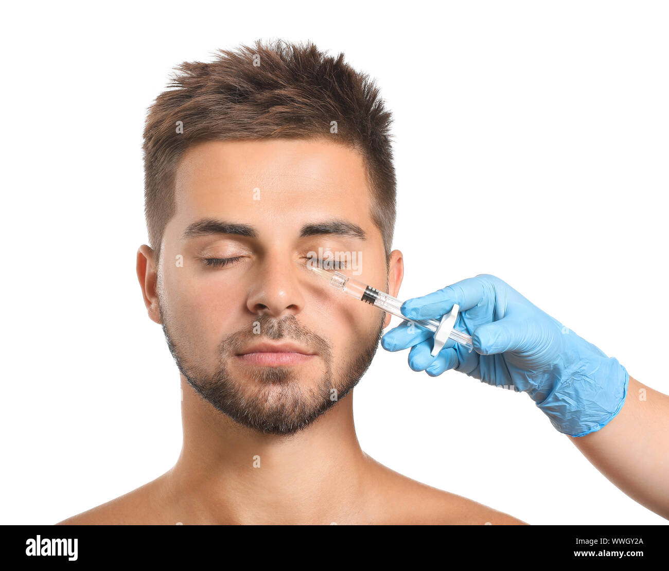 Handsome man receiving filler injection on white background Stock Photo ...
