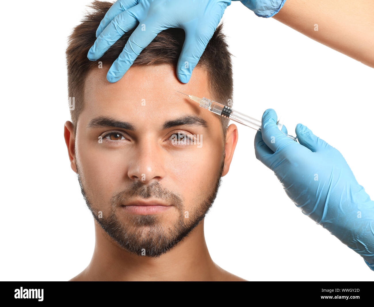 Handsome man receiving filler injection on white background Stock Photo ...