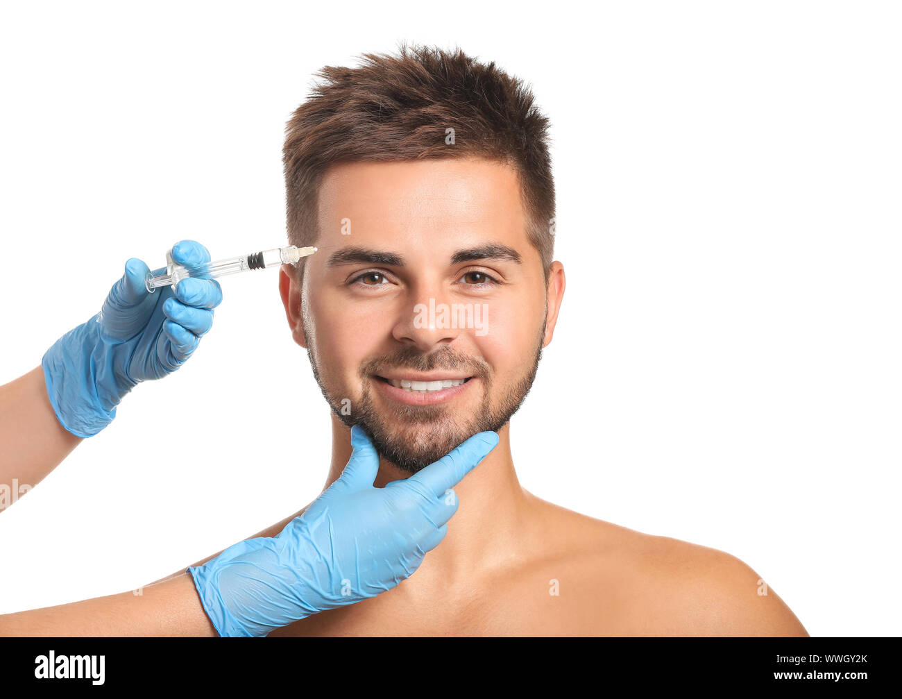 Handsome man receiving filler injection on white background Stock Photo ...