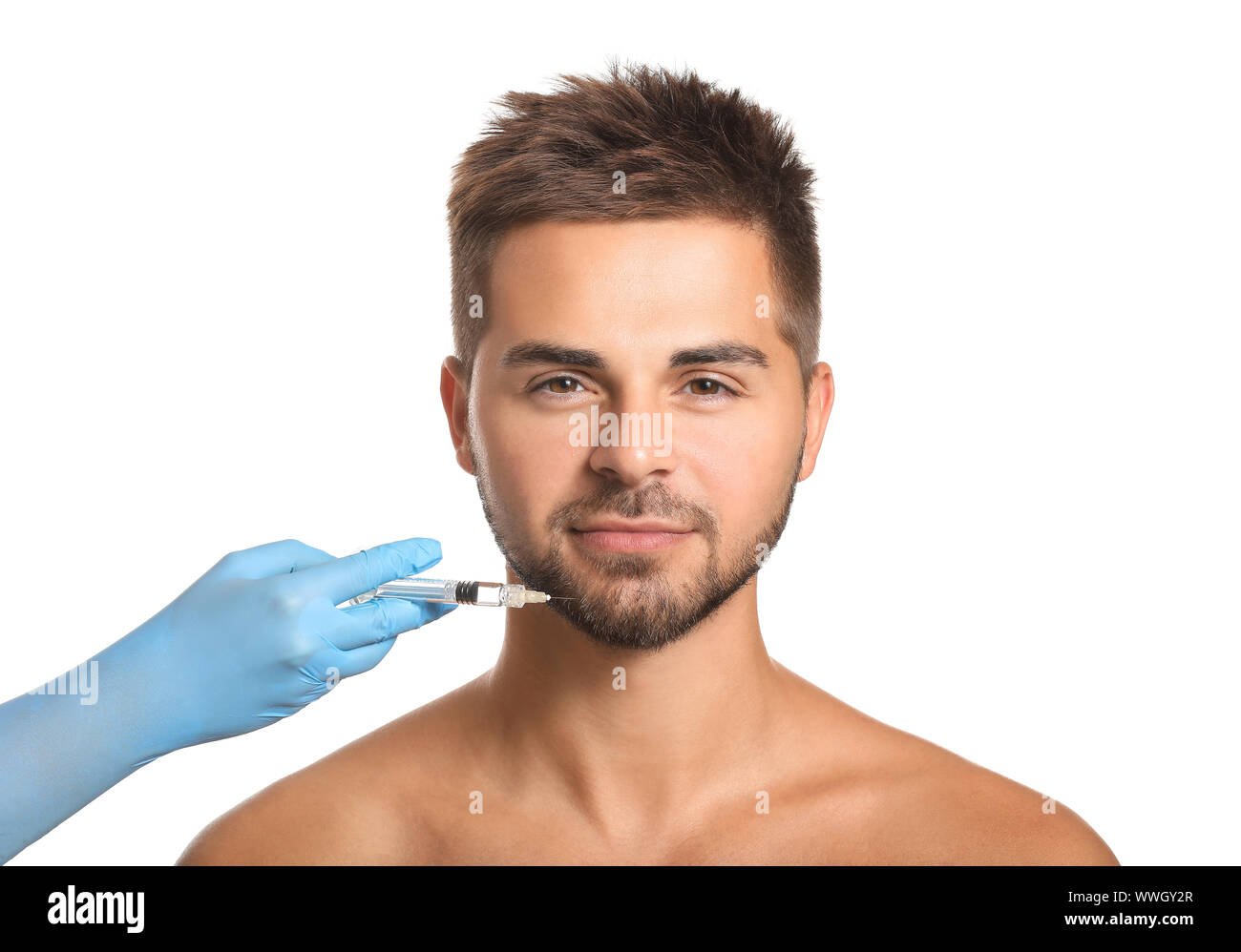 Handsome man receiving filler injection on white background Stock Photo ...