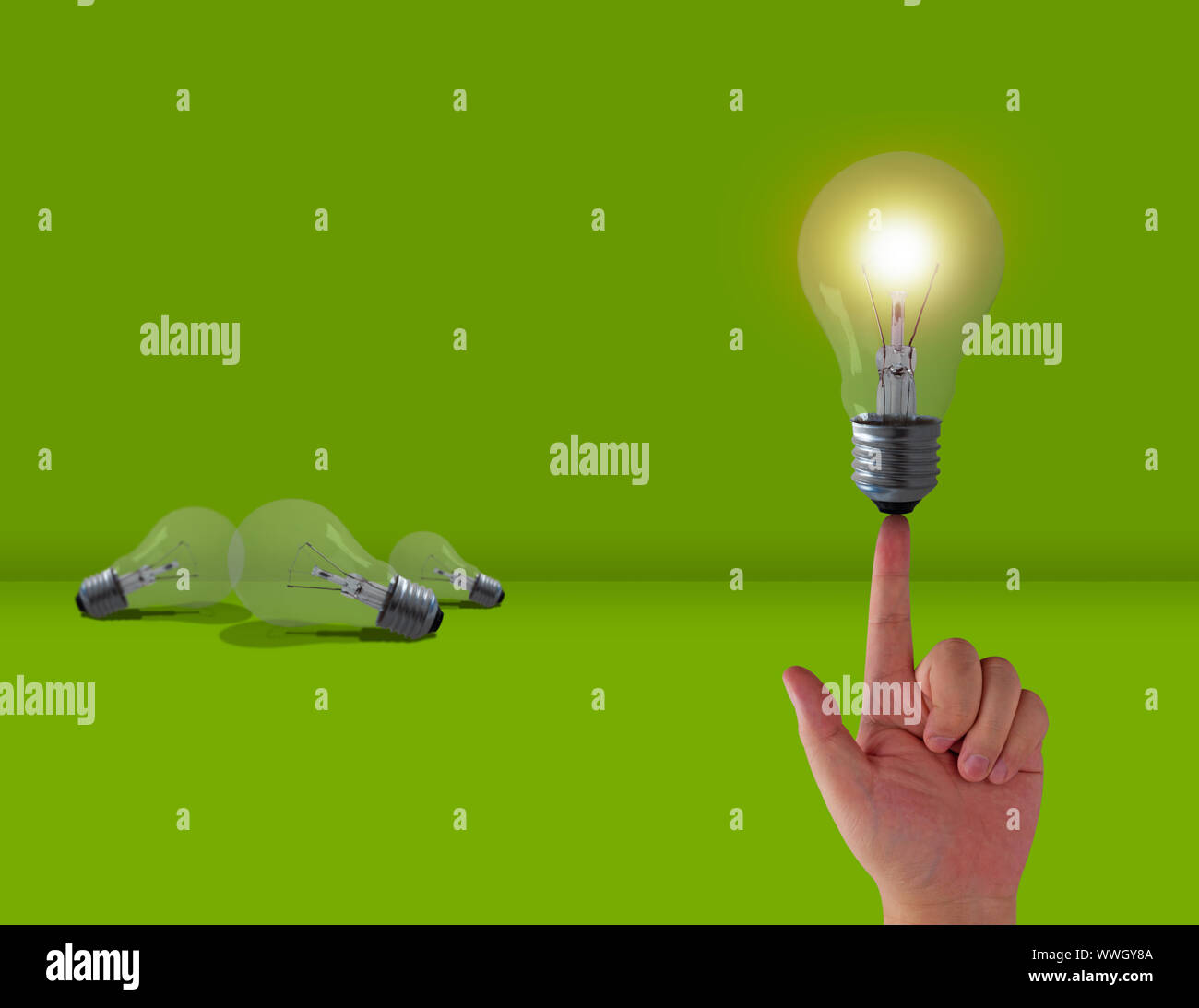 Think different concept, hand and light bulb on green background Stock ...