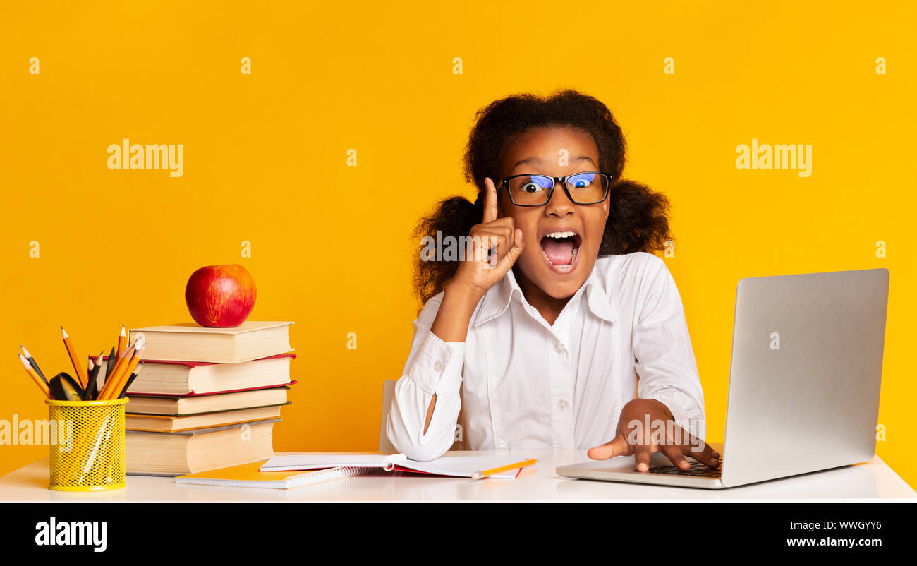School Girl Doing Homework At Laptop Raising Hand In Studio Stock Photo ...