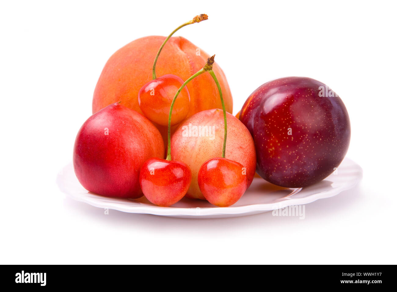 plate with fresh fruits isolated on white background Stock Photo - Alamy