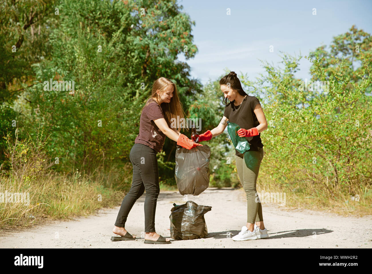 Clean our home together. Group of volunteers tidying up rubbish on ...